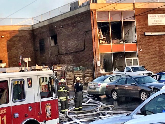 After vehicles fall into burning DC warehouse, fire down to 'hot spots ...